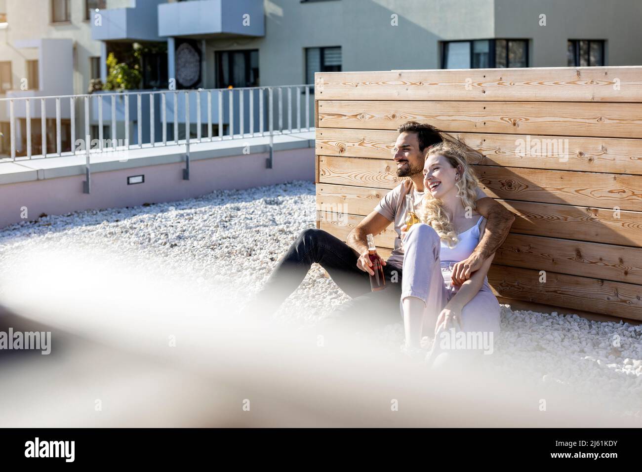 Couple sitting rooftop terrace hi-res stock photography and images - Alamy