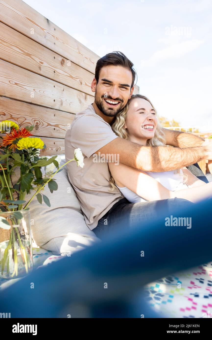 Happy couple resting together on terrace Stock Photo - Alamy