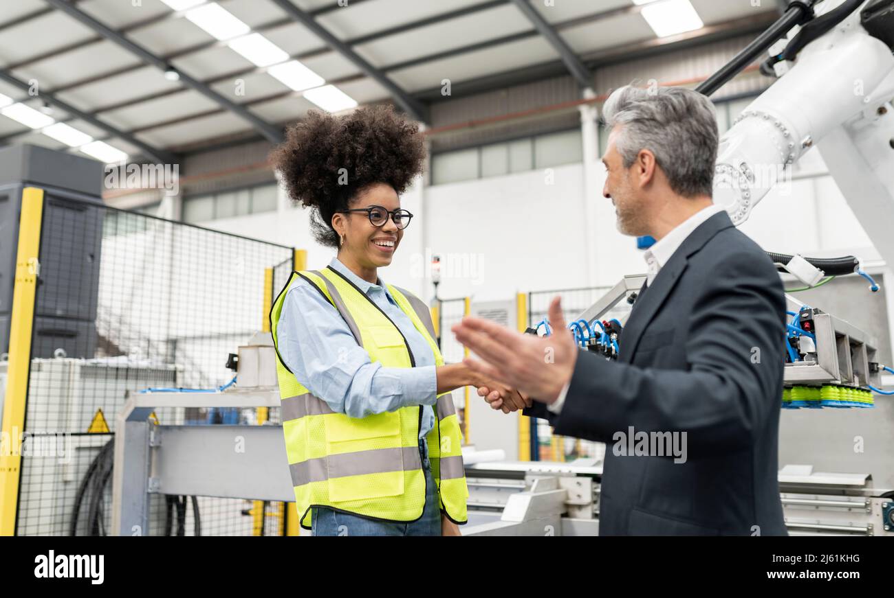 African businessman smiling shaking hand hi-res stock photography and images - Alamy