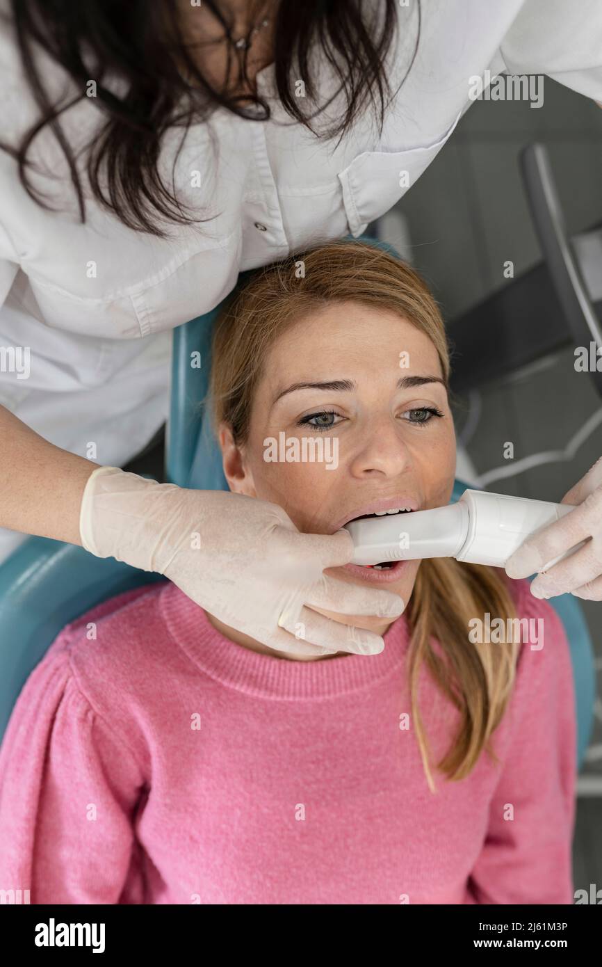 Dentist using dental camera for scanning teeth of patient Stock Photo ...