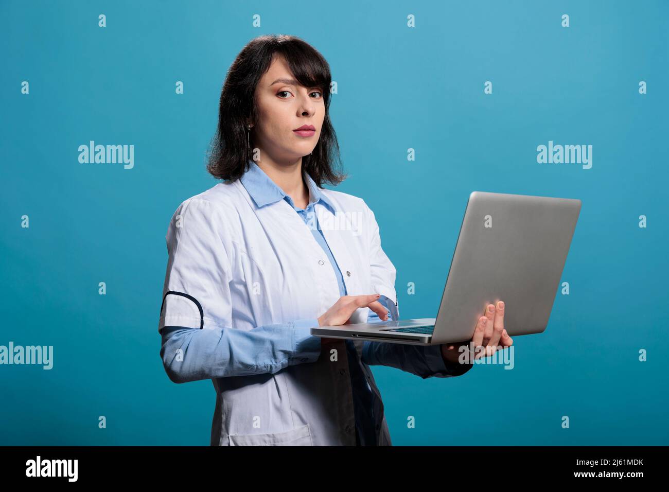 Biochemistry scientist standing on blue background having modern ...
