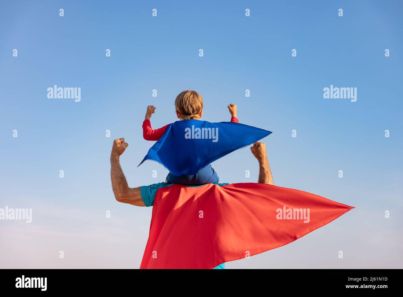 Superhero senior man and child playing outdoor. Super hero grandfather ...