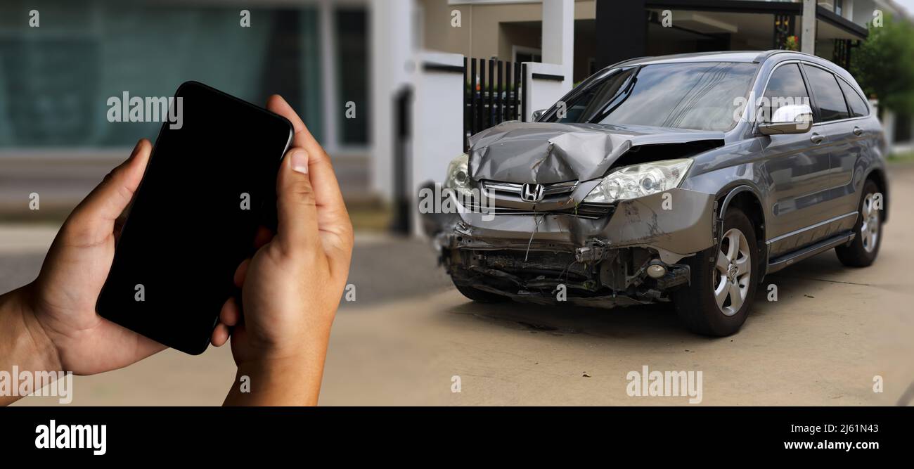 man holding smartphone and take photo of car accident call for help ...