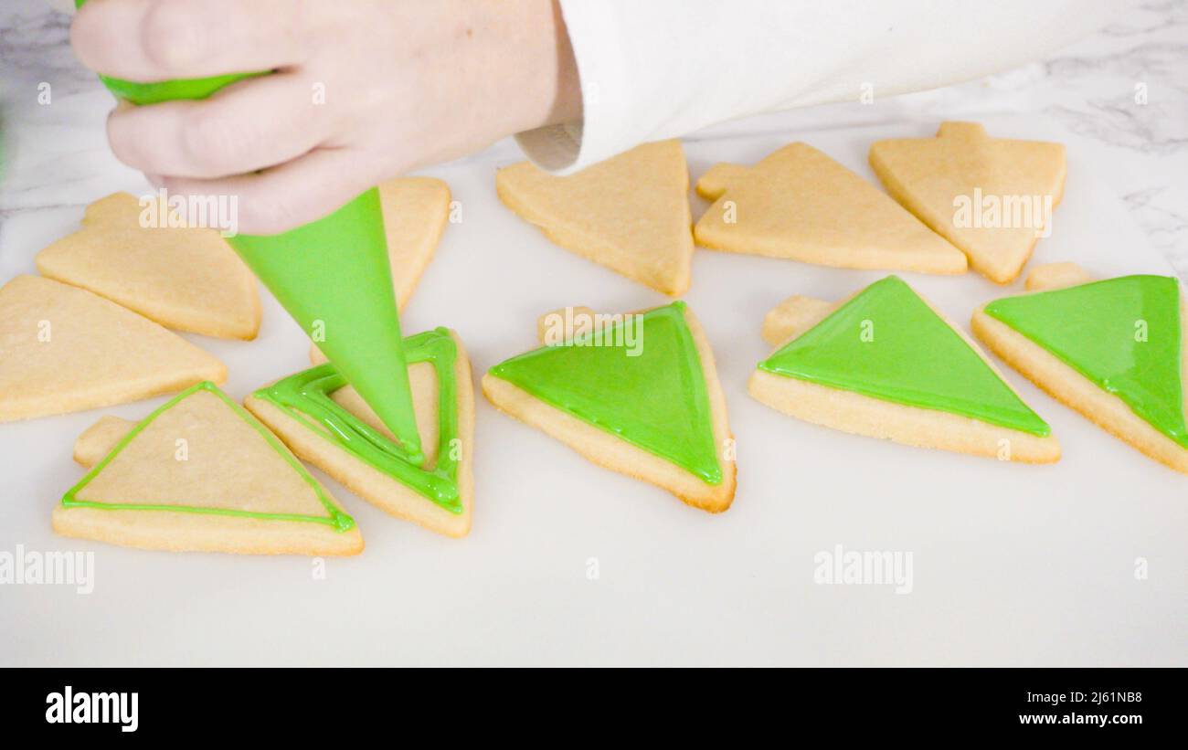 Stp by step. Icing Christmas tree-shaped sugar cookies with green royal ...