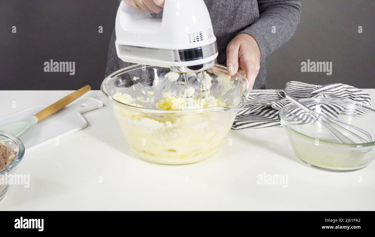 Step by step. Mixing ingredients in a glass mixing bowl to bake ...