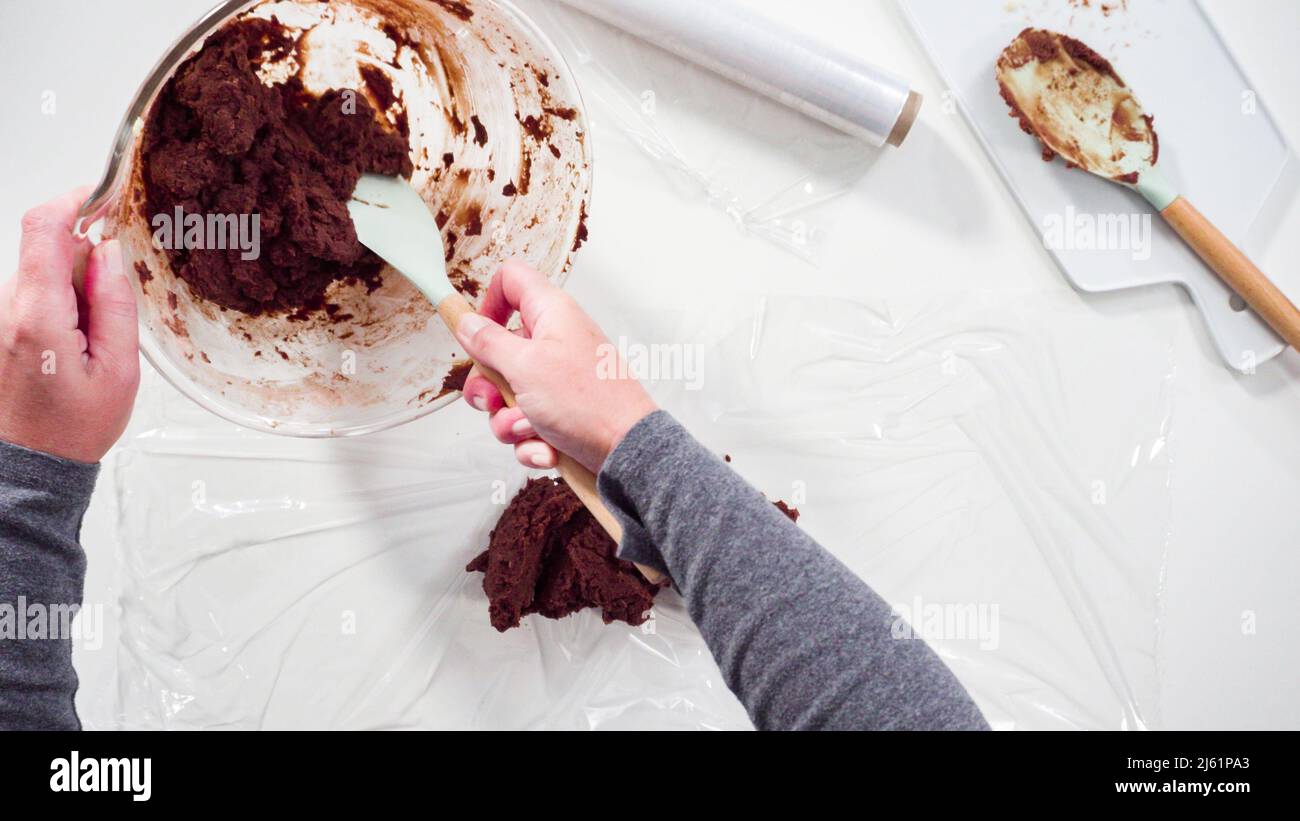Step by step. Flat lay. Wrapping cookie dough into the plastic wrap to ...