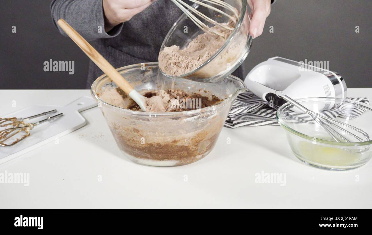 Step by step. Mixing ingredients in a glass mixing bowl to bake ...