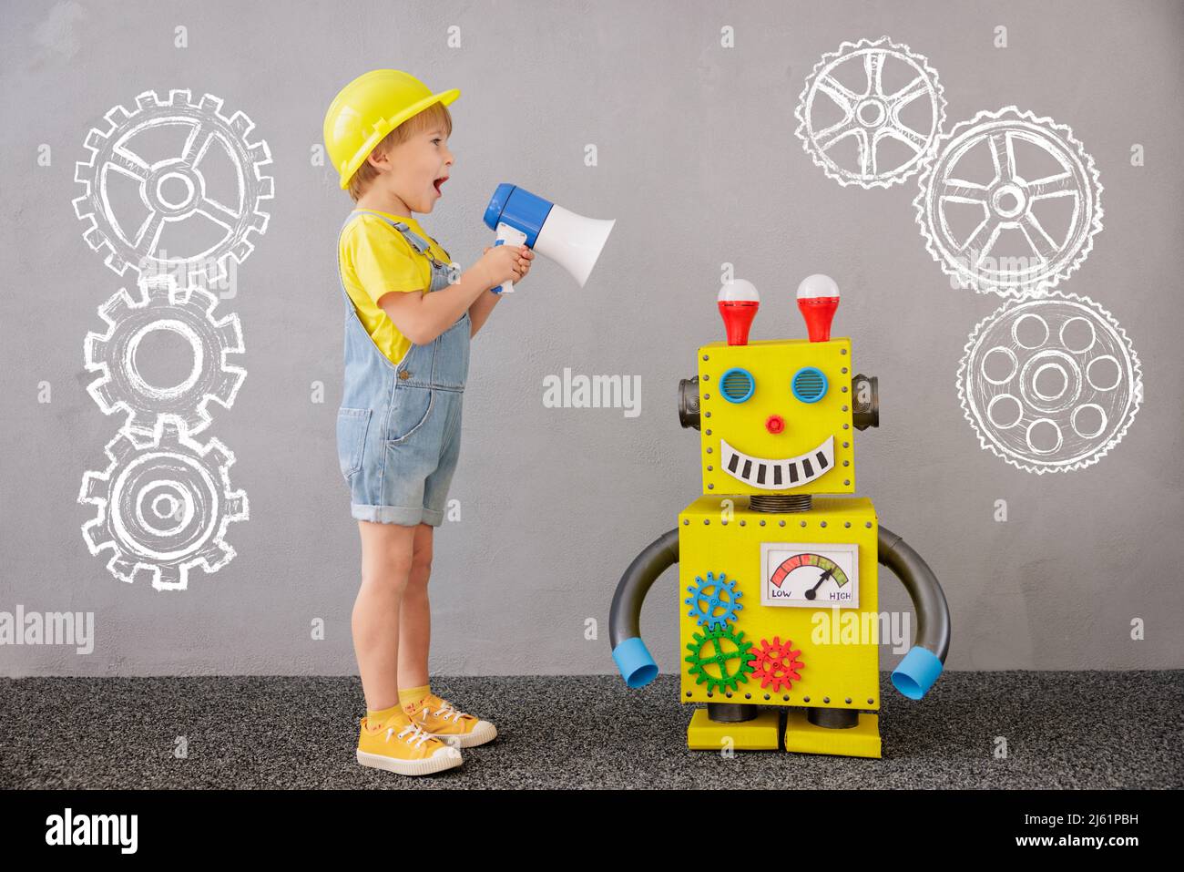 Happy child with robot. Funny kid playing at home. Boy shouting over ...
