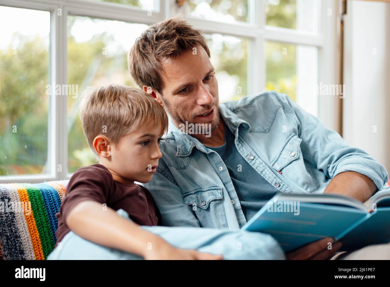 Father son holding book hi-res stock photography and images - Alamy