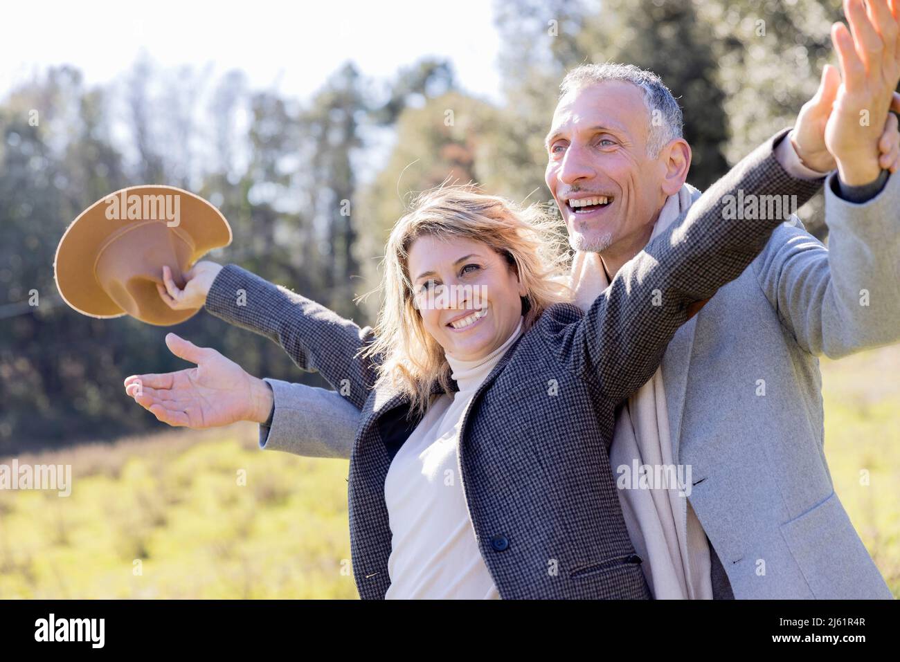 Happy mature couple with arms outstretched on weekend Stock Photo - Alamy
