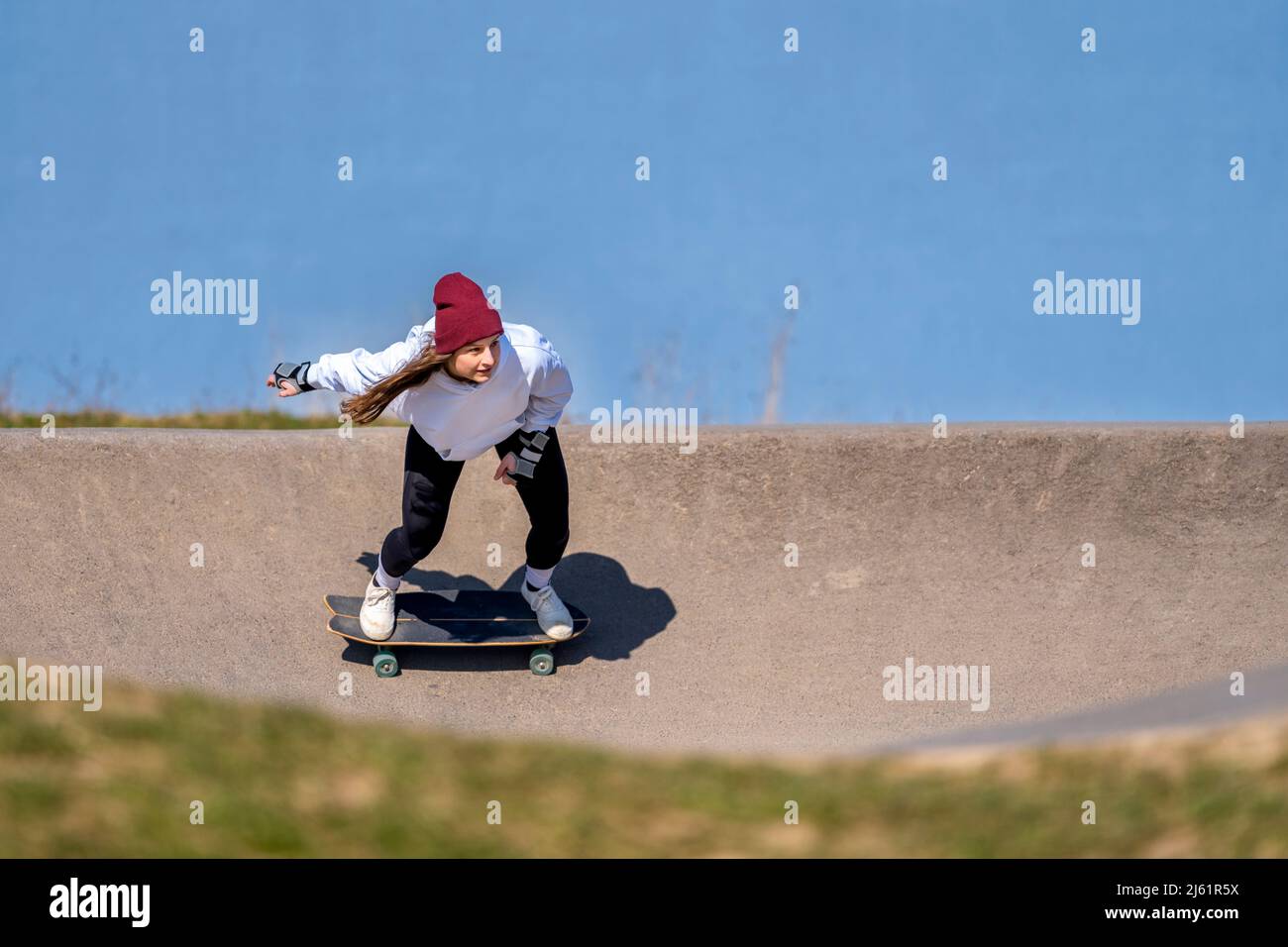 Young woman skateboarding on pump track Stock Photo - Alamy