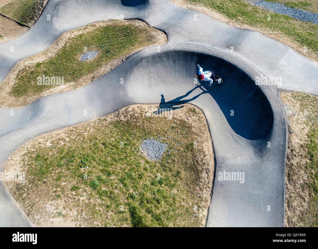 Woman practicing skateboarding at pump track Stock Photo - Alamy
