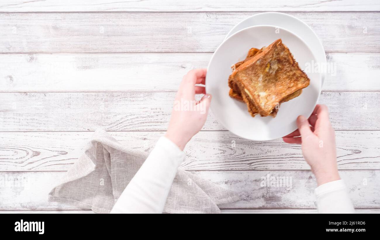 Step by step. Garnishing stack of freshly made french toast with mix ...