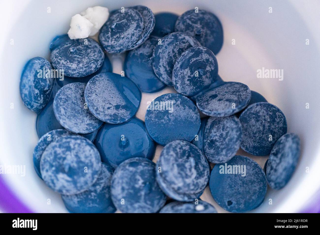 Melting color chocolate chips in electric candy melting pot Stock Photo ...