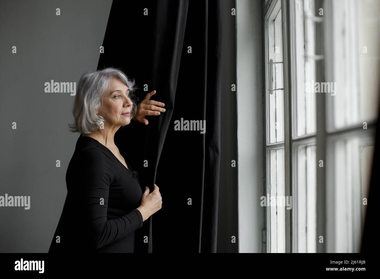 Woman curtain window hi-res stock photography and images - Alamy