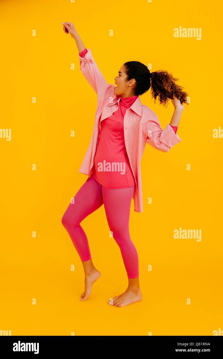 Young woman dancing in yellow hi-res stock photography and images - Alamy