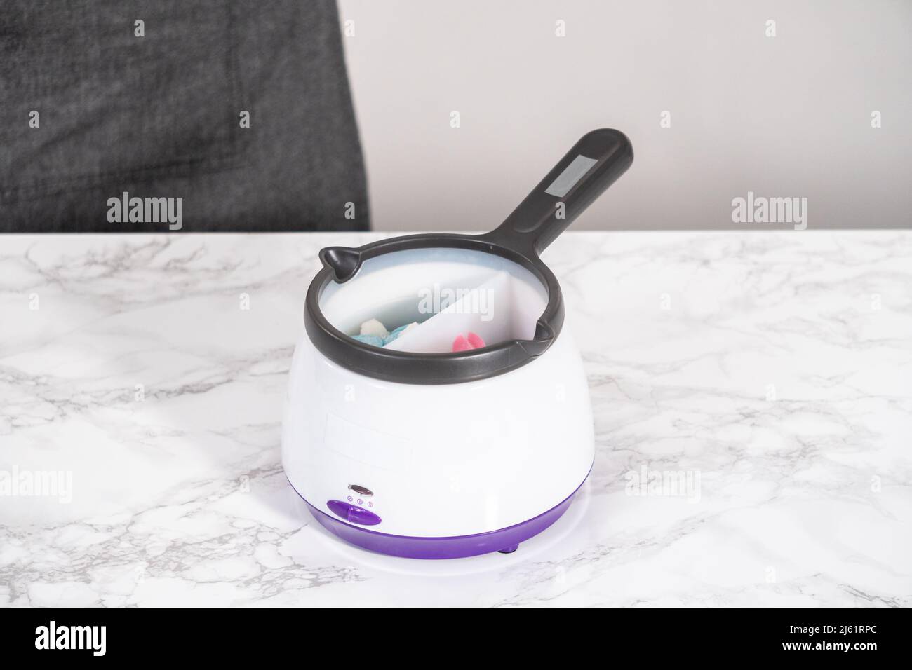 Melting chocolate melts in a candy melting pot to prepare mermaid tails ...