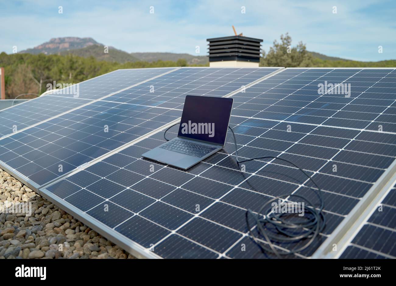 Laptop plugged in with cable on solar panels Stock Photo - Alamy