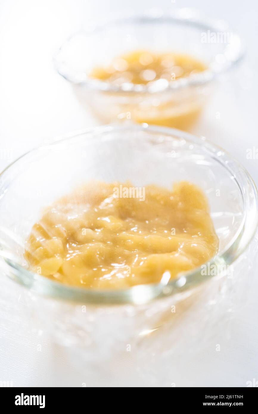 Mashed overripe banana in a glass mixing bowl Stock Photo - Alamy