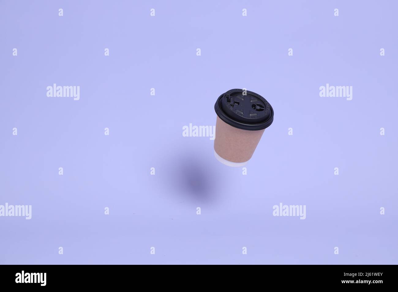 The isolated picture of cup floating on the purple background Stock ...