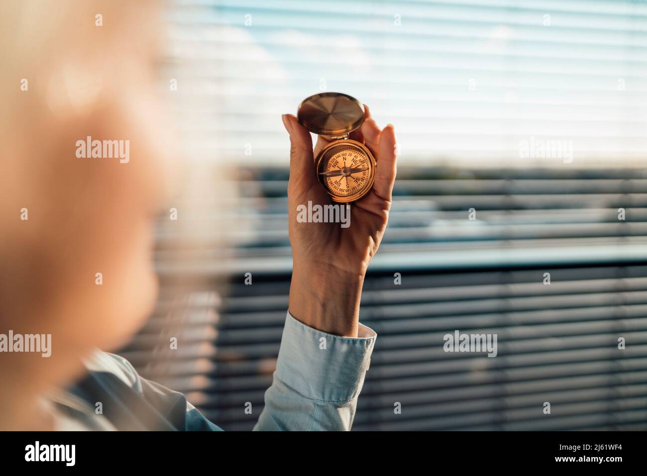 Female hand holding compass hi-res stock photography and images - Alamy