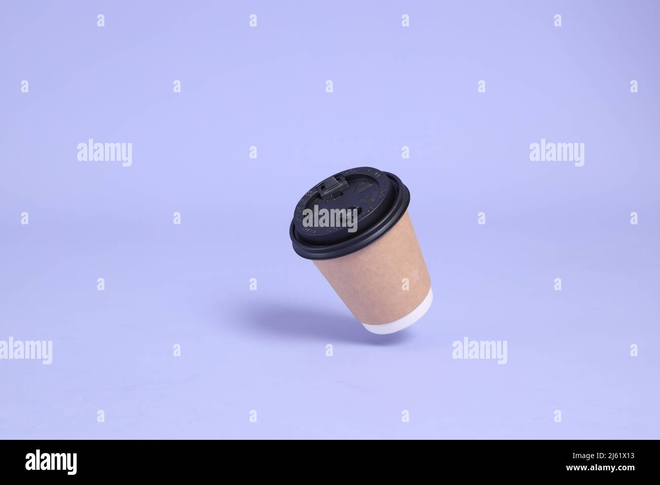 The isolated picture of cup floating on the purple background Stock ...