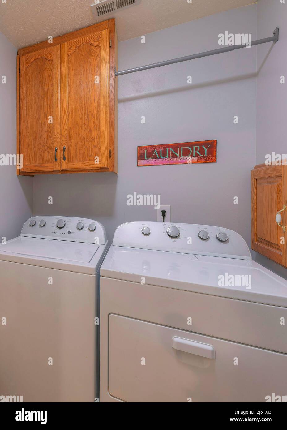 Vertical Laundry room beside the bathroom with large mirror door Stock ...