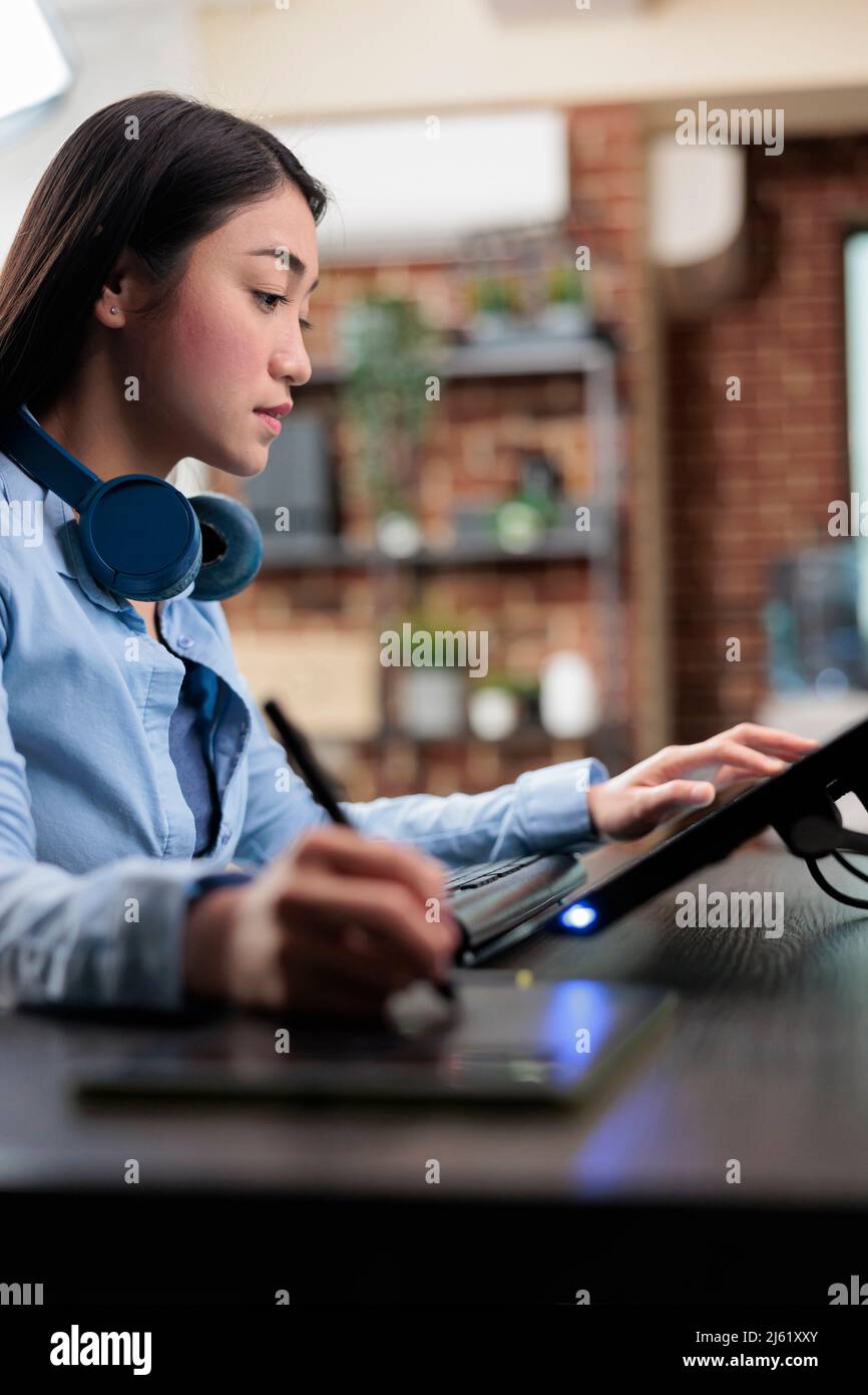 Creative company employee with touchscreen display, graphic tablet and ...