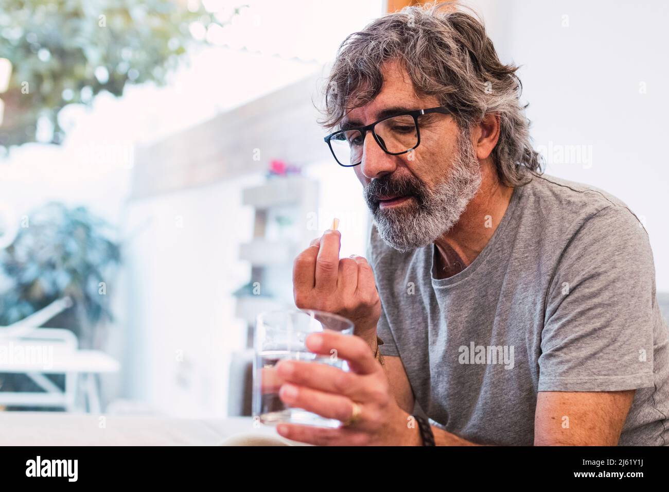 Man taking medicine hi-res stock photography and images - Alamy