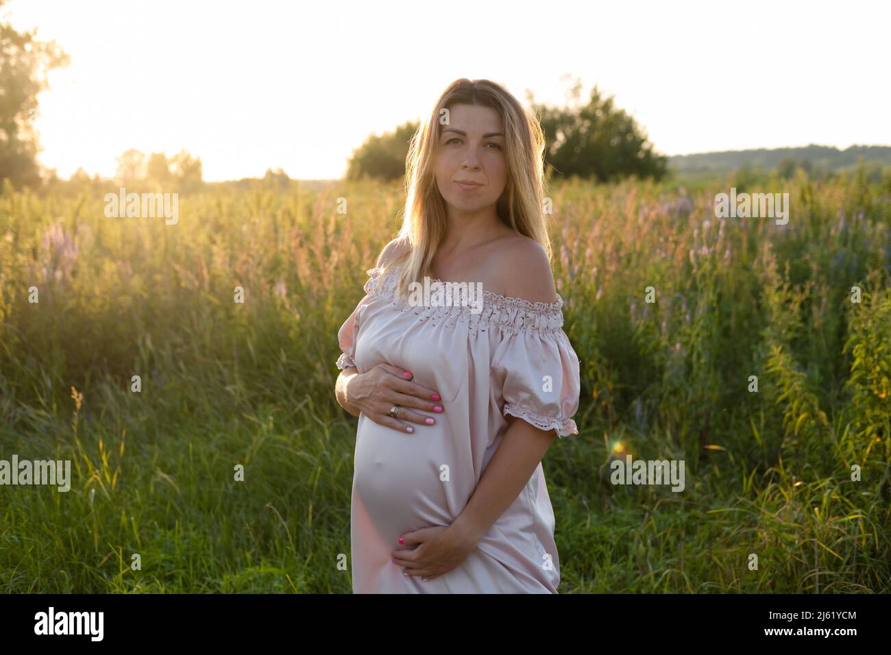 tender pregnancy portrait on sunset. expecting mother to be outside in ...