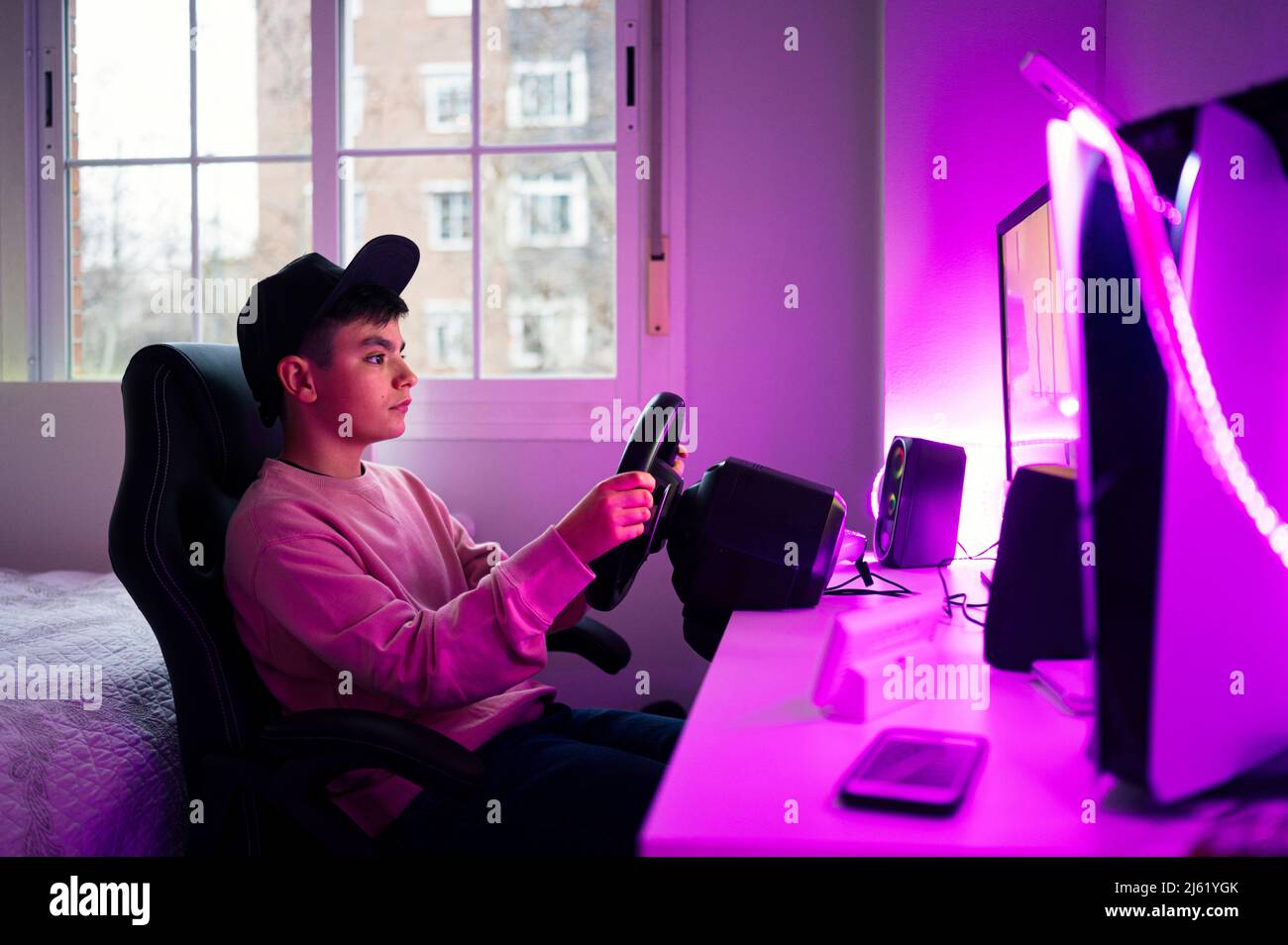 Boy playing video game on computer in bedroom at home Stock Photo - Alamy