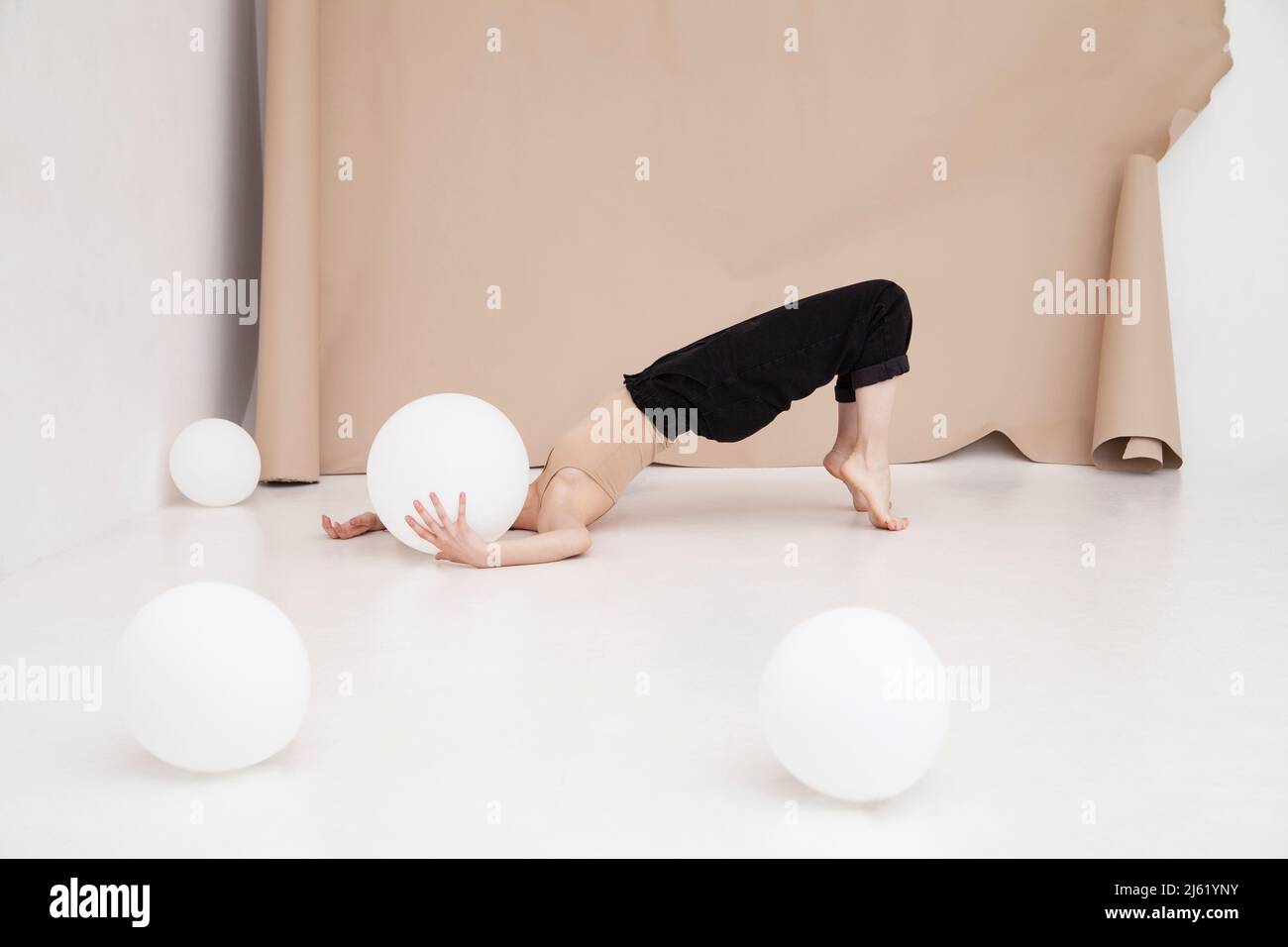 Young woman with balloon practicing yoga by brown backdrop Stock Photo ...