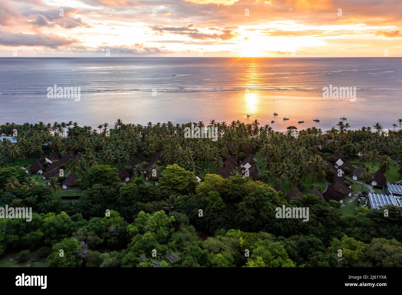 Helicopter view forested shore coastal village indian ocean sunset hi ...