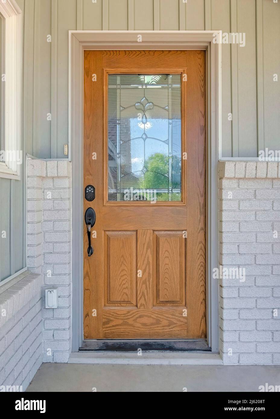 Vertical Front wooden door exterior with ornate glass panel and digital ...