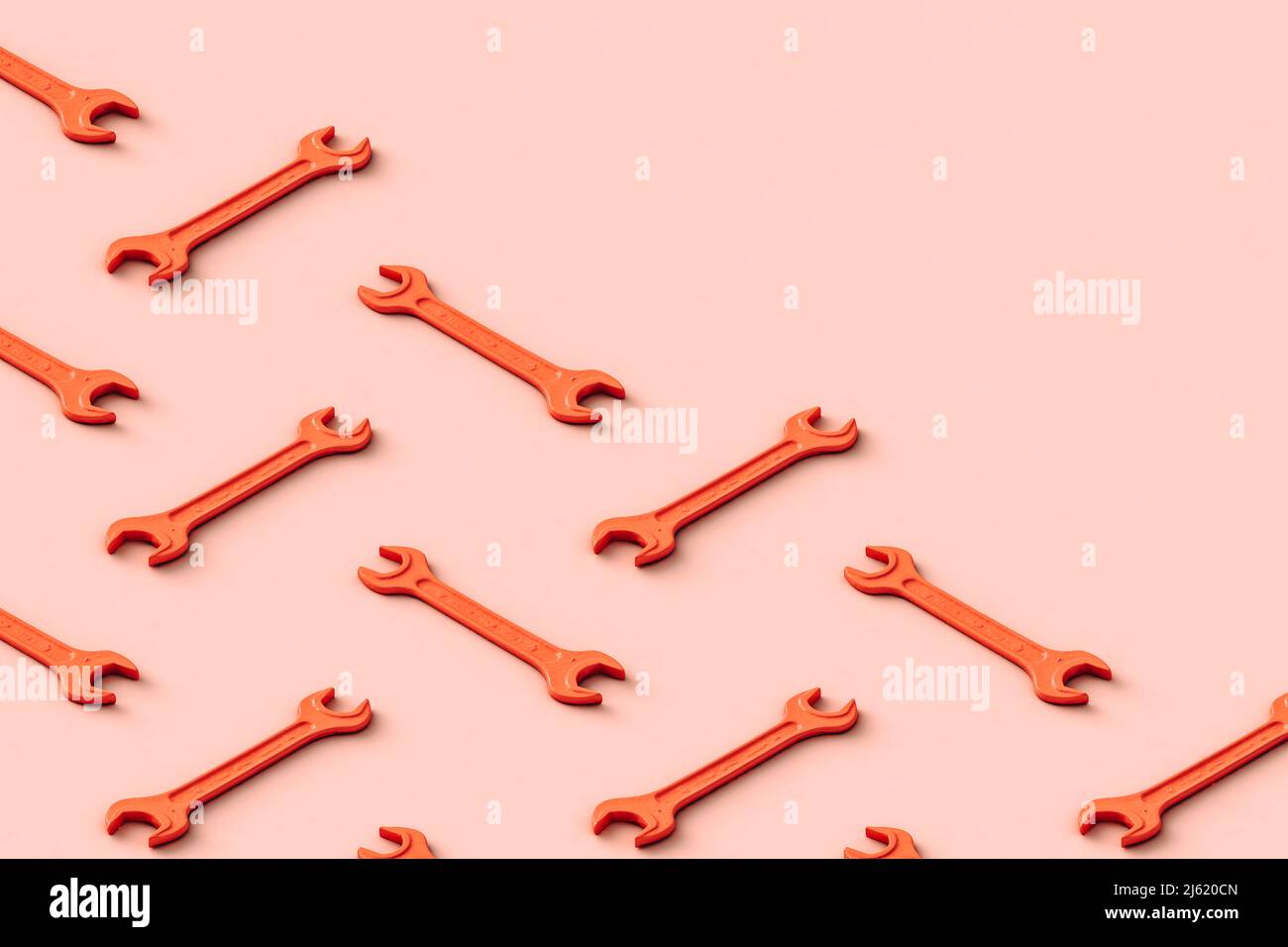 Three dimensional pattern of rows of orange colored wrenches flat laid ...