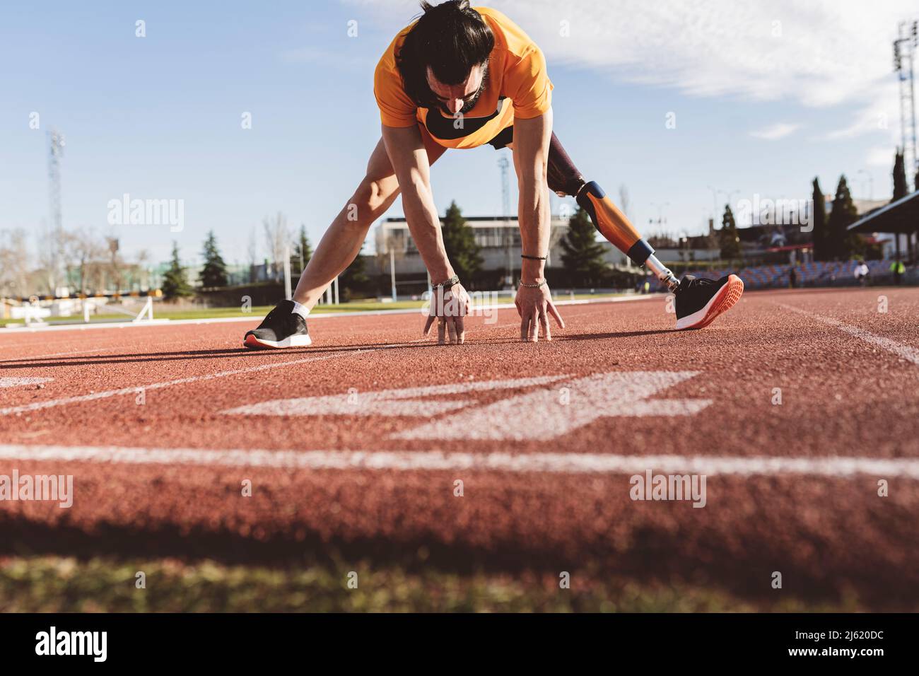 Athlete with prosthetic leg exercising on running track Stock Photo - Alamy