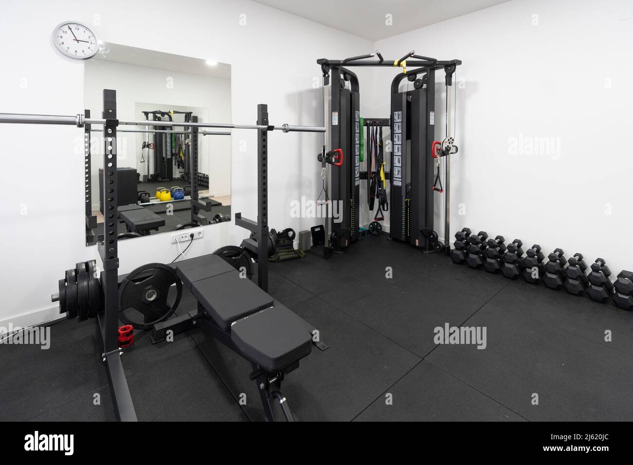 Exercise equipment and dumbbells in empty health club Stock Photo - Alamy