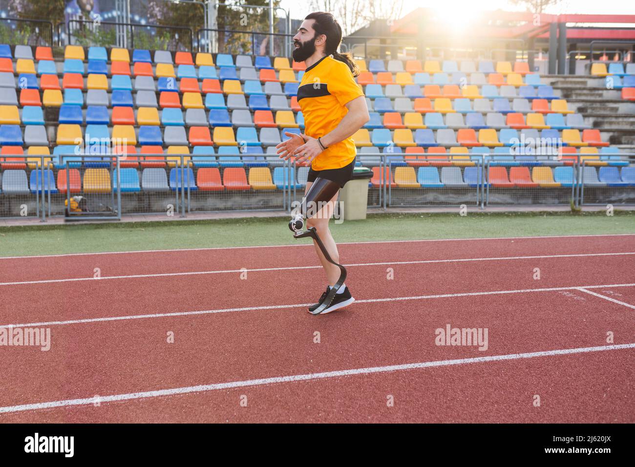 Athlete with prosthetic leg running on sports track Stock Photo - Alamy