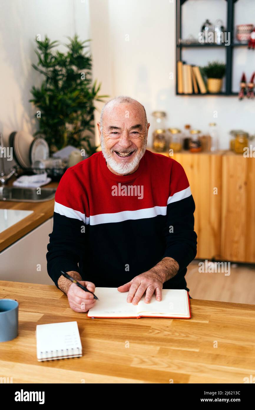 Portrait cheerful senior man holding hi-res stock photography and ...