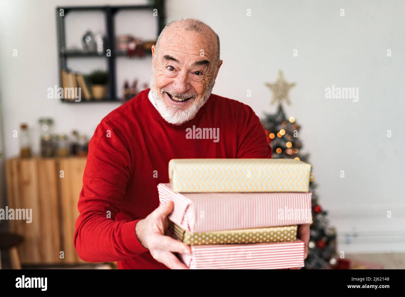 Senior man giving box hi-res stock photography and images - Alamy