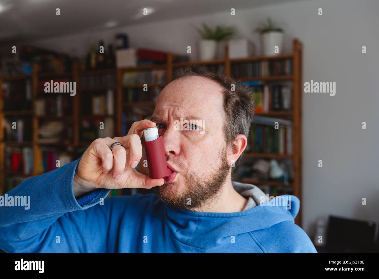 Man using asthma inhaler at home Stock Photo - Alamy