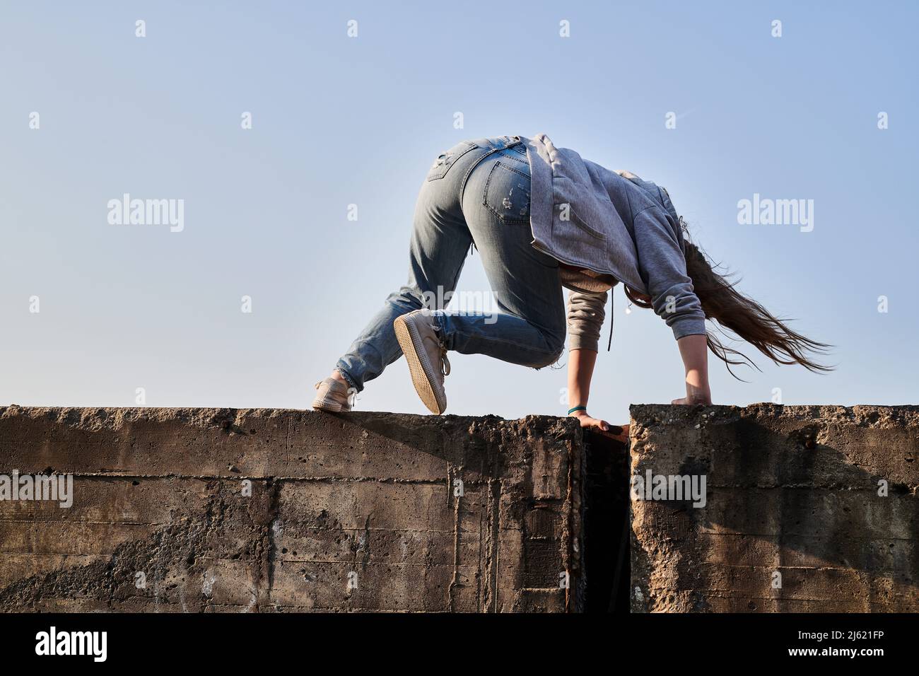Person climbing over wall hi-res stock photography and images - Alamy