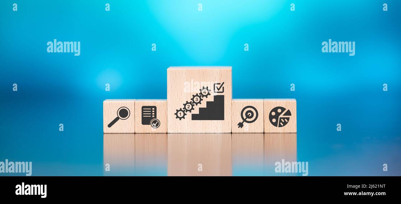 Wooden blocks with symbol of action plan concept on blue background ...