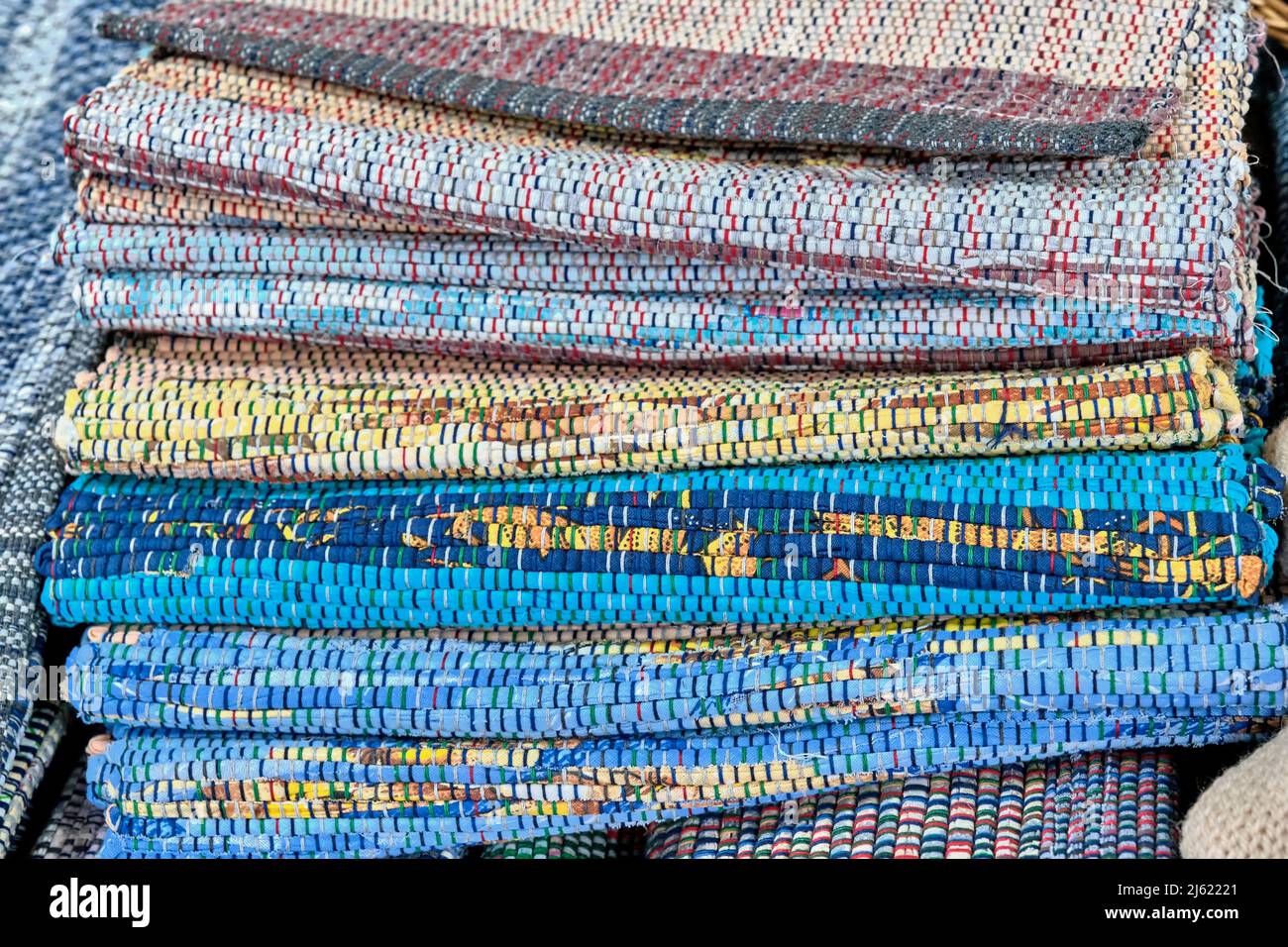 Home colourful woven mats stacked Stock Photo - Alamy