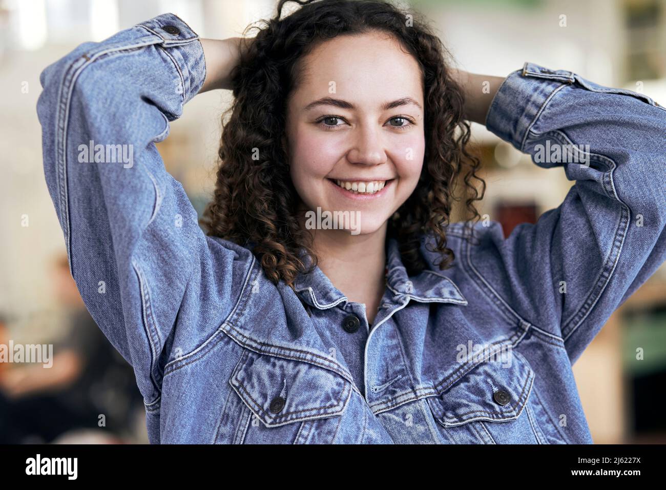 Woman hands behind head smiling hi-res stock photography and images - Alamy