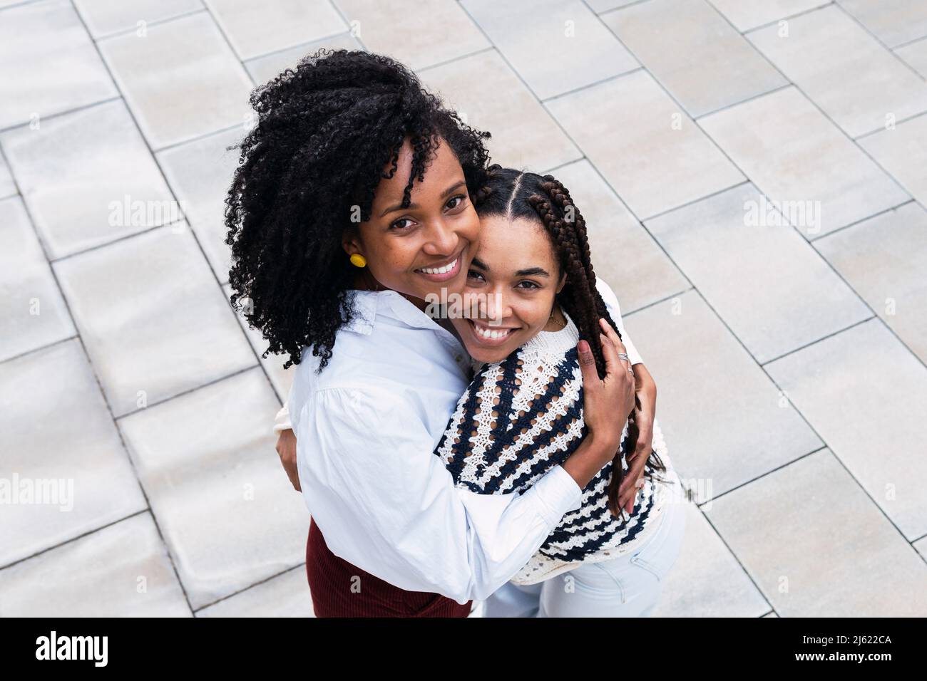 Happy business colleagues hugging each other at office park Stock Photo ...