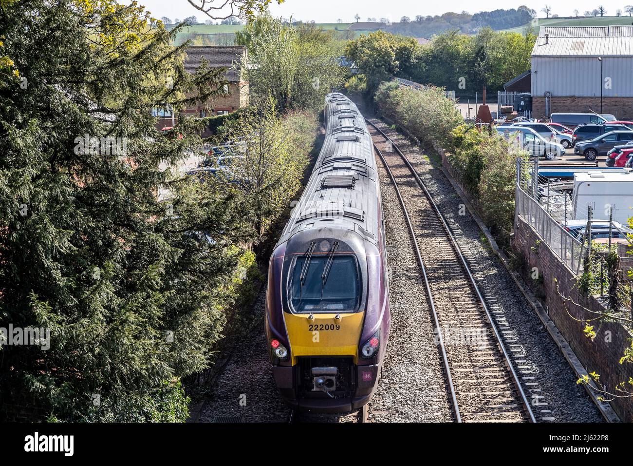Diesel-electric passenger train leaving Oakham station, looking down ...