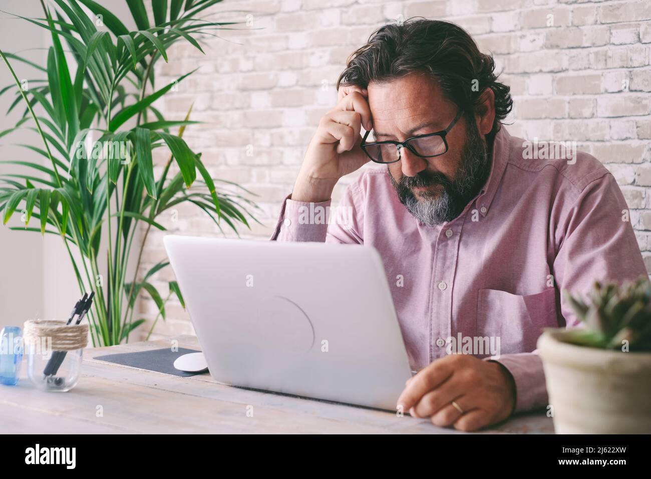 Sad looking men sitting table hi-res stock photography and images - Alamy