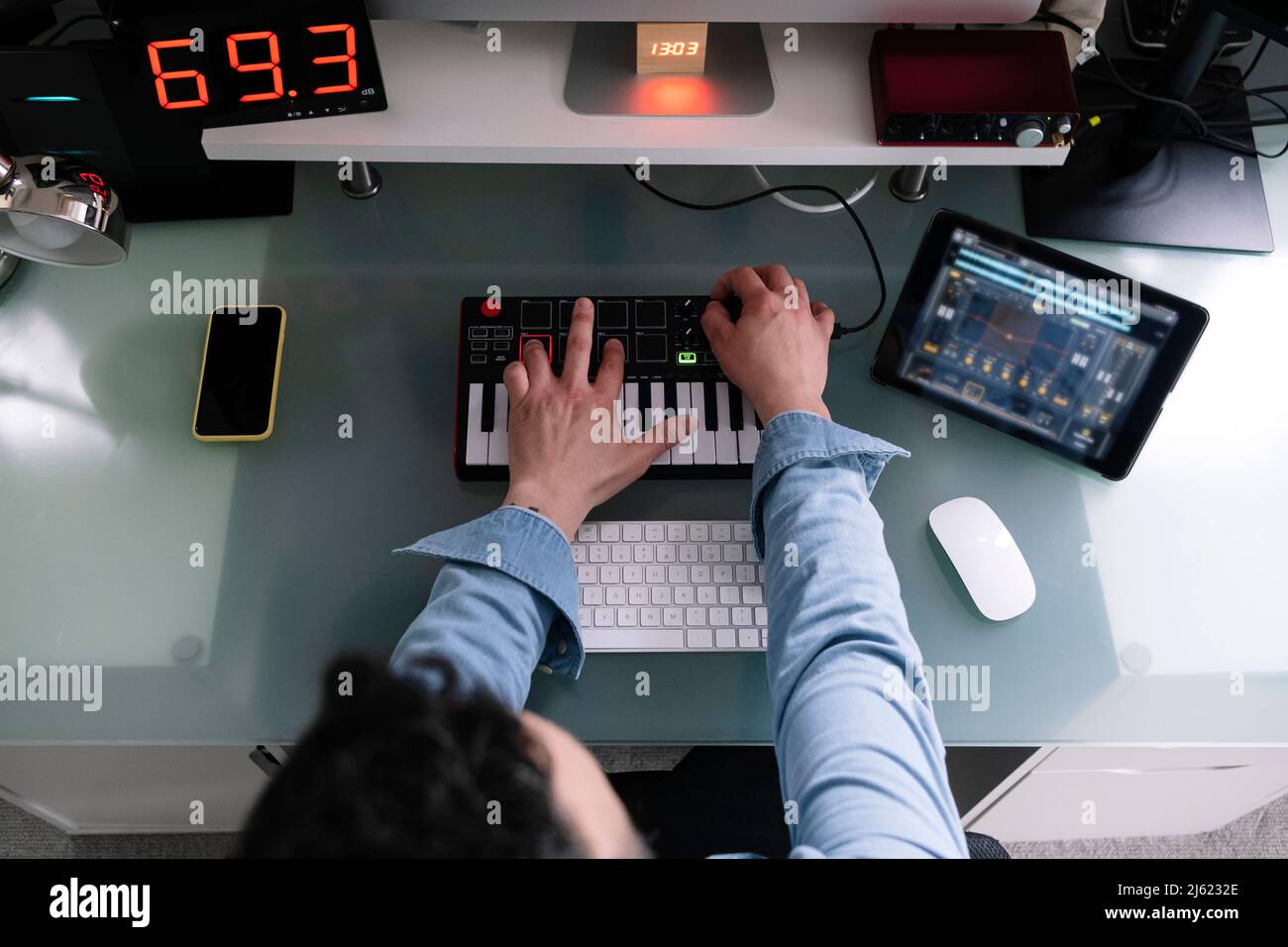 Freelancer creating music with piano keys at home studio Stock Photo ...