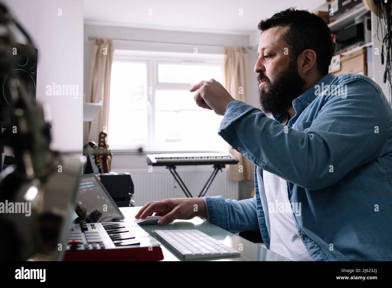 Freelancer gesturing and creating music at home studio Stock Photo - Alamy